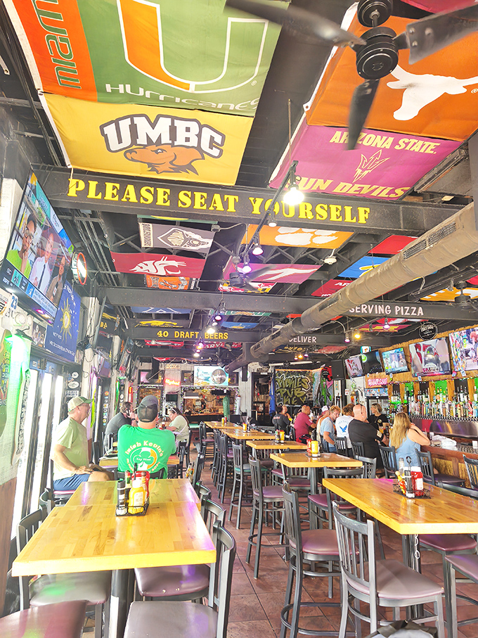 College pennants hang from the ceiling like trophies of academic achievement, reminding us that education continues long after graduation&mdash;especially at bars.