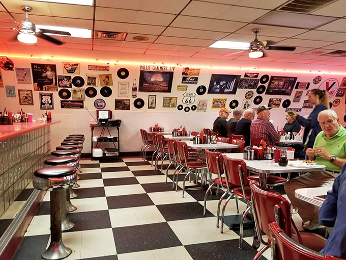The checkered floor and red booths create the perfect backdrop for morning conversations. These aren't just diners&mdash;they're breakfast philosophers.