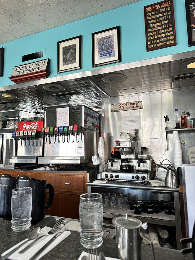 The drink station&mdash;where coffee flows freely and the "Free Lunch Tomorrow" sign has been making the same joke for decades.