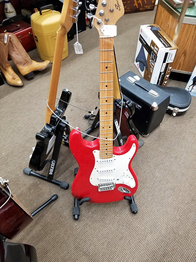 Rock star dreams in standby mode&mdash;this cherry-red Stratocaster waits patiently for its next gig, surrounded by musical companions.