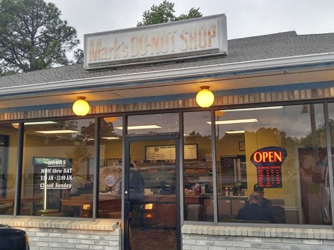 In the soft glow of early morning or late afternoon, Mark's storefront becomes a portal to a simpler, sweeter time.