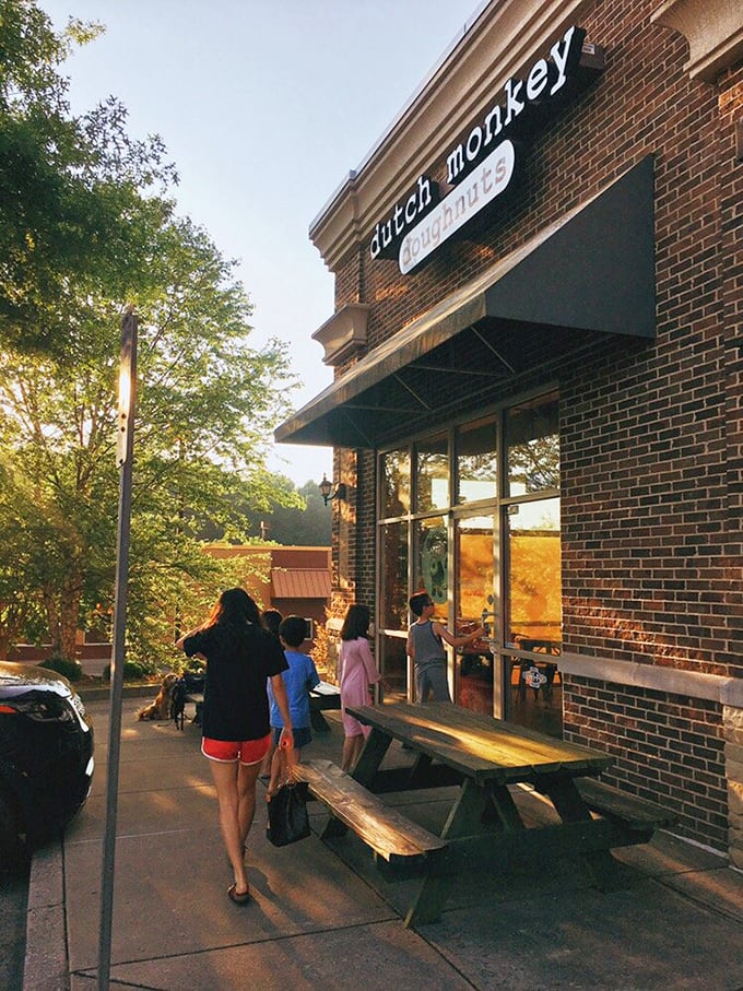 Morning sunshine casts a golden glow on Dutch Monkey's entrance, where picnic tables await those wise enough to arrive before the "Sold Out" sign appears.