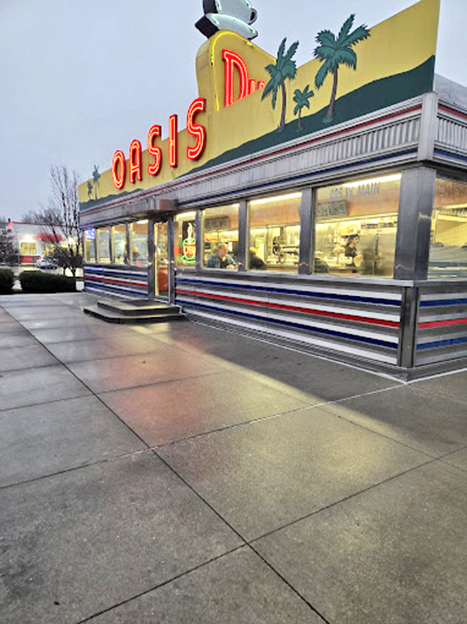 As evening falls, the neon "OASIS" sign glows like a lighthouse for the hungry, its palm tree motif promising a tropical oasis of flavor in the Indiana heartland.