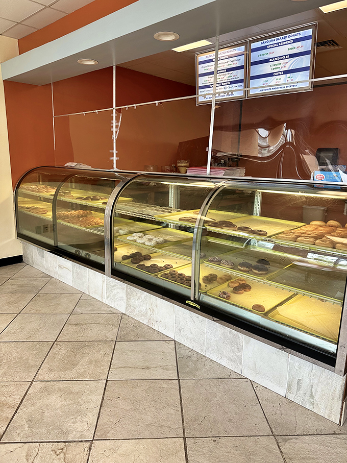 The display case of dreams! Behind this glass lies a wonderland of fried dough possibilities just waiting to brighten your day.