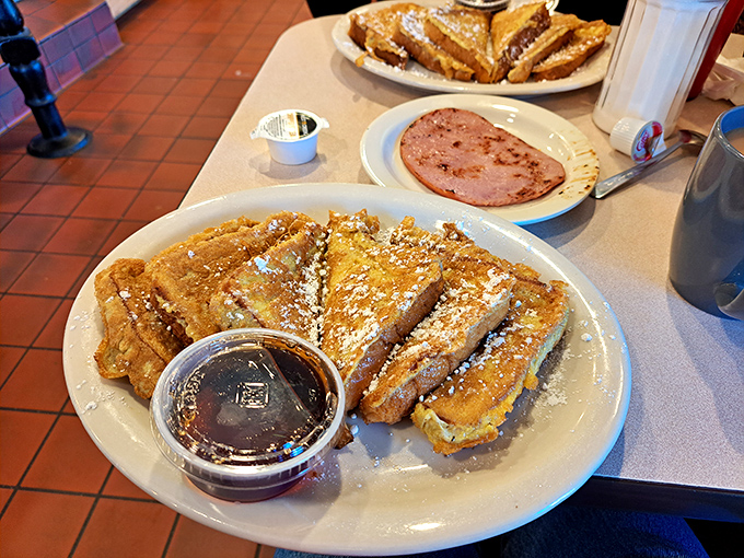 French toast that makes you understand why the French are so smug about their cuisine. That powdered sugar snowfall is breakfast elegance.