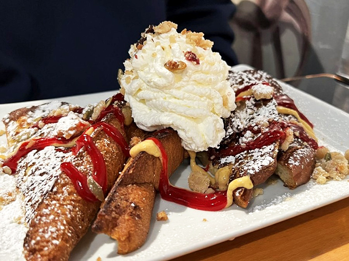 French toast that crosses the line from breakfast to dessert, crowned with a cloud of whipped cream and drizzled with enough sauce to make you forget about maple syrup.