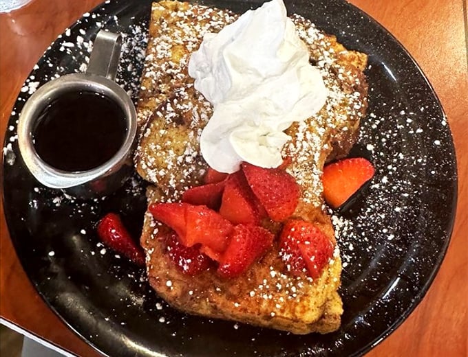 French toast that's dressed for success with powdered sugar, fresh strawberries, and whipped cream&mdash;breakfast masquerading as dessert, and nobody's complaining.