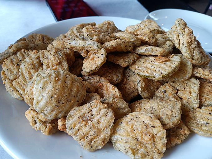 Fried pickles that achieve the impossible: maintaining their crunch while delivering tangy satisfaction. The perfect sidekick to any seafood feast.