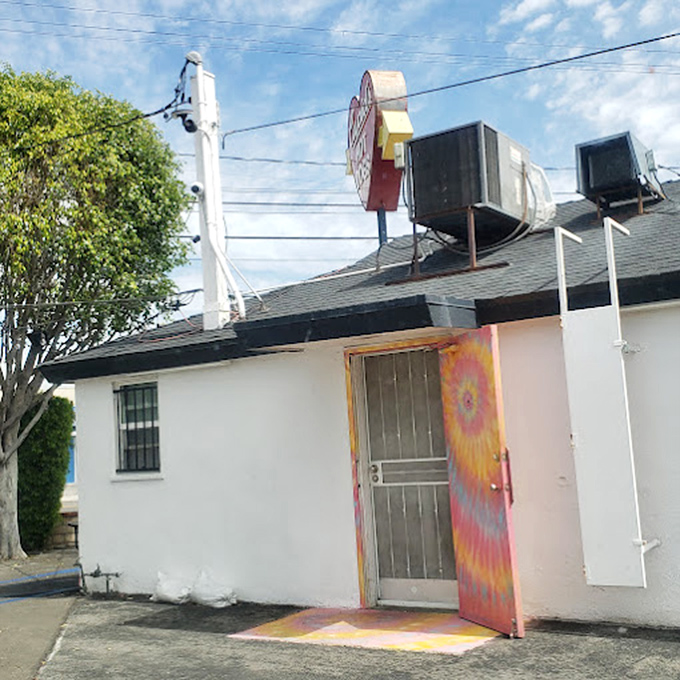 That tie-dyed door entrance isn't just colorful &ndash; it's a portal to a simpler time when lunch didn't need to be complicated to be perfect.