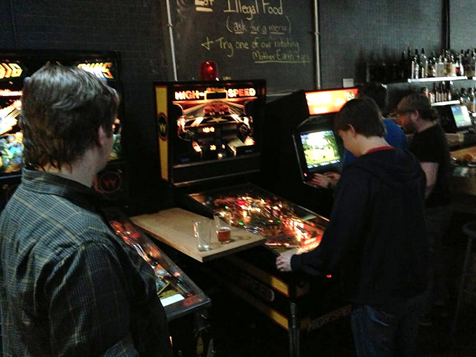 Pinball wizards in their natural habitat – where the satisfying clack of flippers and the glow of playfields create a timeless gaming experience.