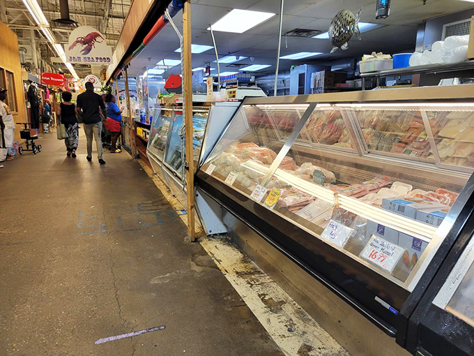Meat counters and display cases create the market's main artery, pumping shoppers through a gauntlet of temptation. The weekend ritual of browsing and buying.