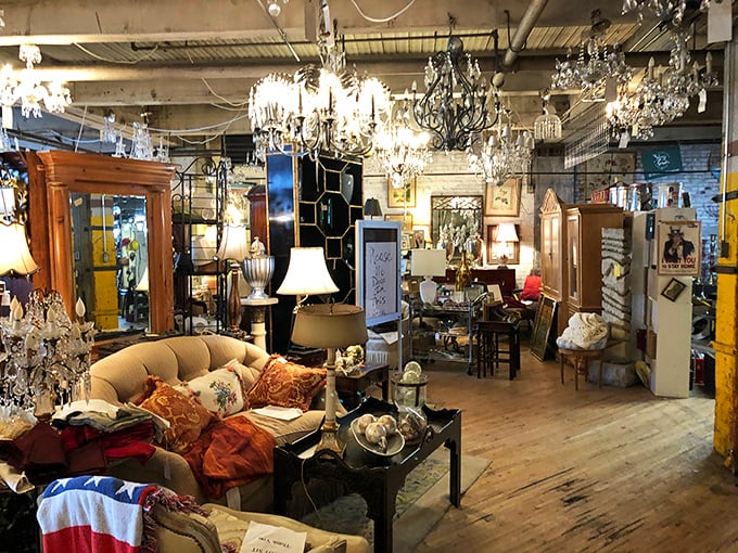 Sunlight streams through factory windows, illuminating a landscape of vintage sofas, chandeliers, and the ghosts of Indianapolis's industrial past.