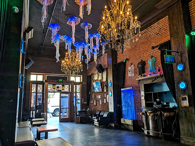 Elegant chandeliers juxtaposed with glowing jellyfish create a space that's equal parts Victorian parlor and 20,000 Leagues Under the Sea. Steampunk meets splash punk.
