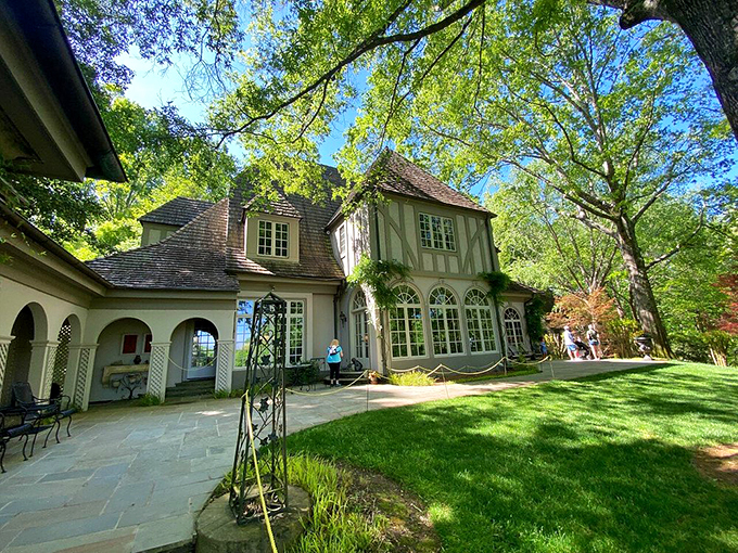 The manor house emerges from its garden setting like a French countryside estate transported to the Georgia hills by some benevolent gardening wizard.