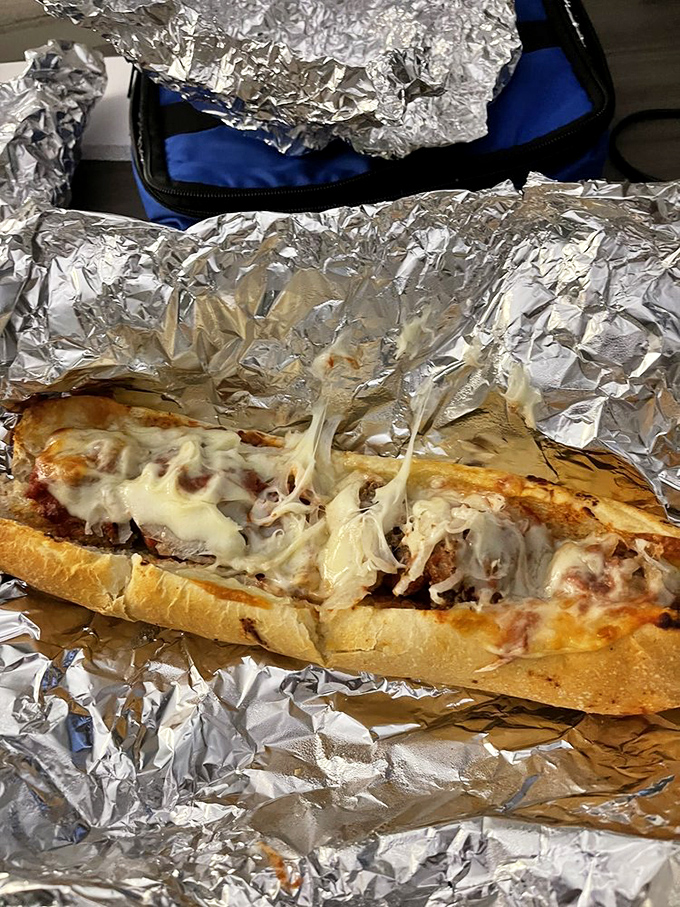 The meatball grinder—where Italian-American dreams come true in sandwich form. That cheese pull is performing gravity-defying feats worthy of a circus.