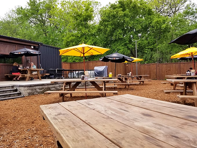 Minnesota summers were made for this outdoor dining area, where yellow umbrellas dot wooden picnic tables like cheerful mushrooms after a rain.