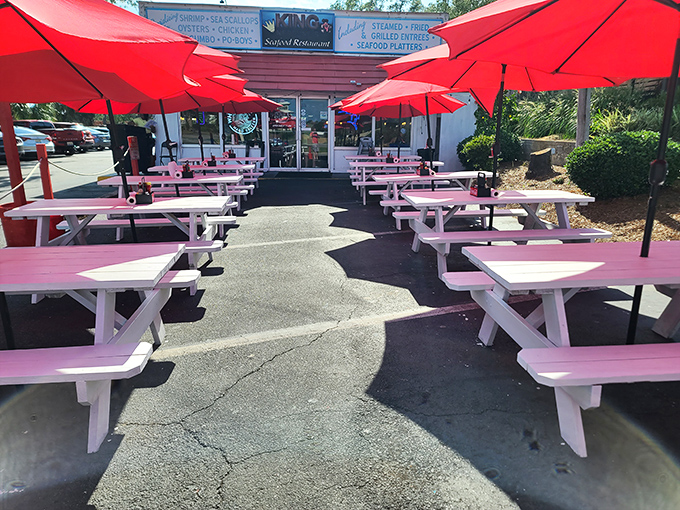 Picnic tables under red umbrellas—simple perfection for seafood feasting. No white tablecloths needed when the food speaks this loudly.