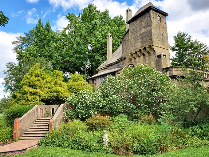The castle emerges from lush gardens like something from a fairytale, if fairytales included reinforced concrete and architectural innovation.