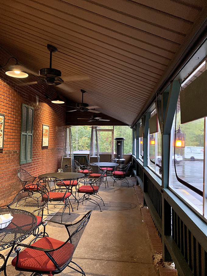 The screened porch dining area&mdash;where summer evenings stretch into night and nobody wants to leave until the last bite is gone.