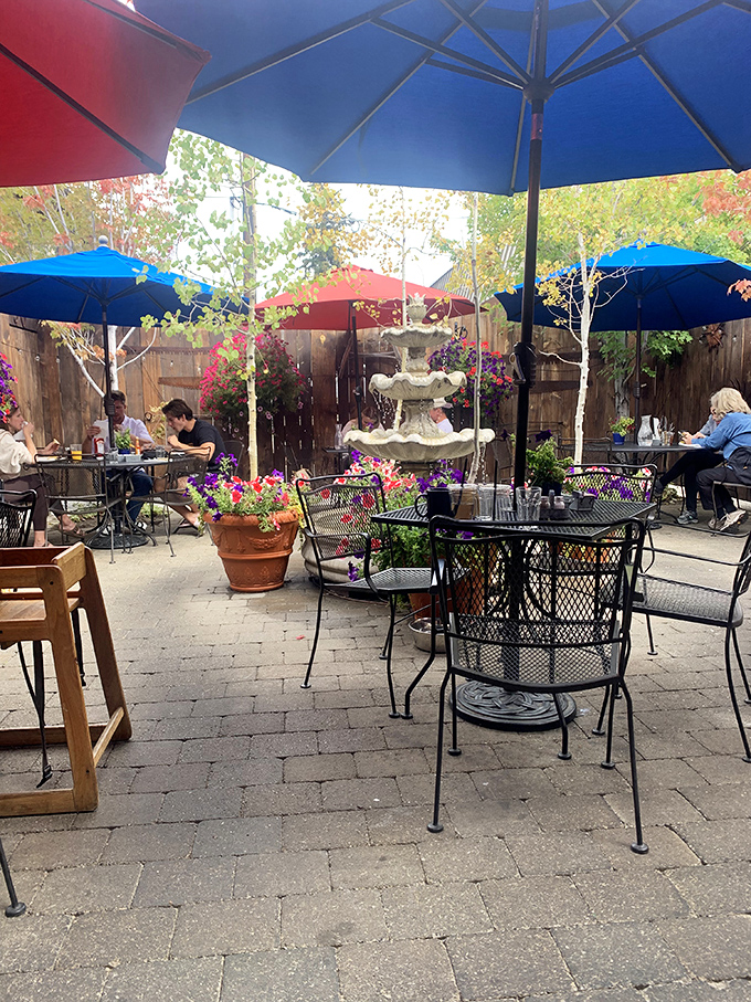The secret garden patio where summer breakfasts come with a side of mountain air and the gentle music of a bubbling fountain.