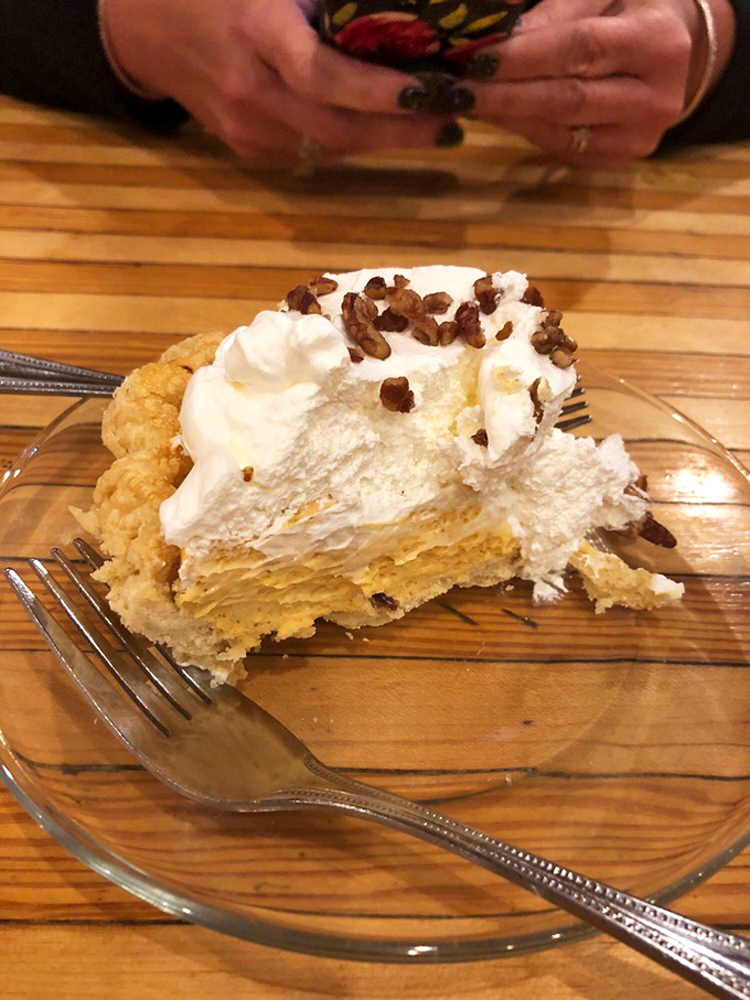 Pie that makes you question why you saved room for dessert instead of ordering it first. That whipped cream mountain deserves its own topographical map.