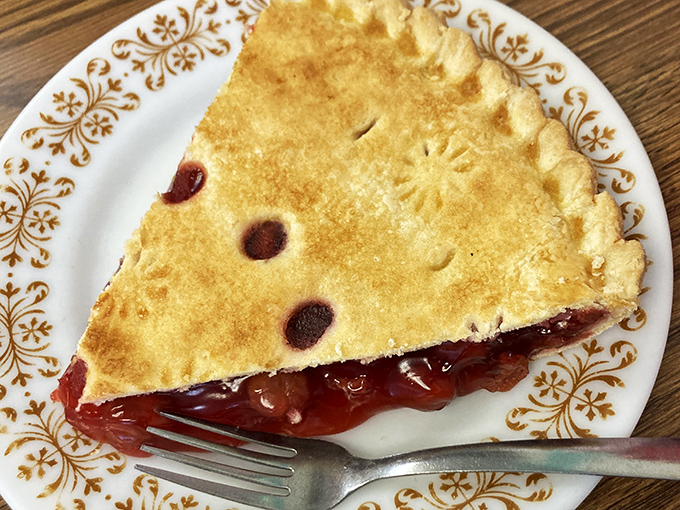 Cherry pie that would make Agent Cooper weep with joy. The crimped edges and bubbling fruit filling tell you someone's grandmother is working kitchen magic.