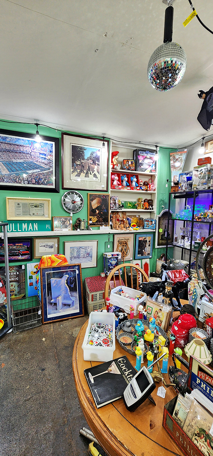 A disco ball presides over pop culture relics and Beatles memorabilia. This corner feels like the inside of a particularly interesting mind.