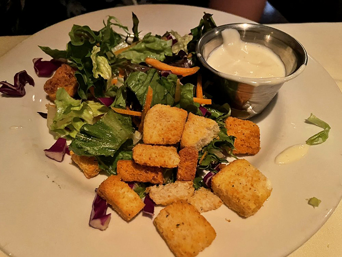 Even the salad gets the royal treatment here, with fresh greens and house-made croutons that refuse to be mere supporting actors.