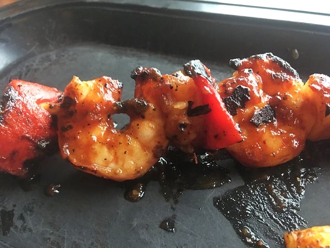 Grilled shrimp with a kiss of char and a glaze that glistens &ndash; proof that Skeeter's mastery extends beyond traditional barbecue fare.