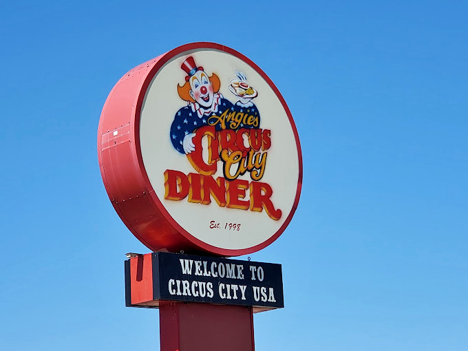 The sign stands tall against the Oklahoma sky, a beacon for hungry travelers and locals alike. "Welcome to Circus City USA" indeed!