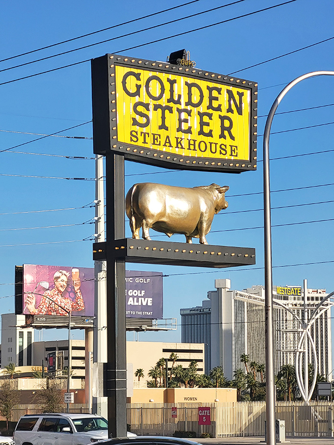 The iconic Golden Steer sign with its golden bull stands proud against the Vegas sky—a beacon for those seeking steak salvation amid the neon wilderness.