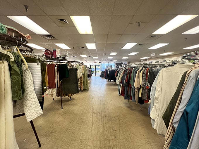 The clothing corridor stretches toward the horizon like a fabric-lined runway, each hanger a potential fashion revelation waiting to be discovered.
