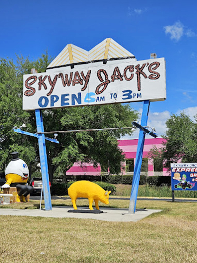The sign promises "OPEN 5AM TO 3PM" while a yellow pig statue stands guard. Because why have one quirky mascot when you can have several?