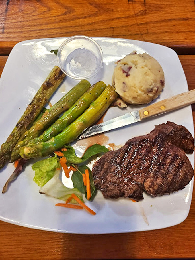 A perfectly seared steak shares the spotlight with grilled asparagus and homemade mashed potatoes. Even in a seafood haven, the land-based options demand respect and admiration.