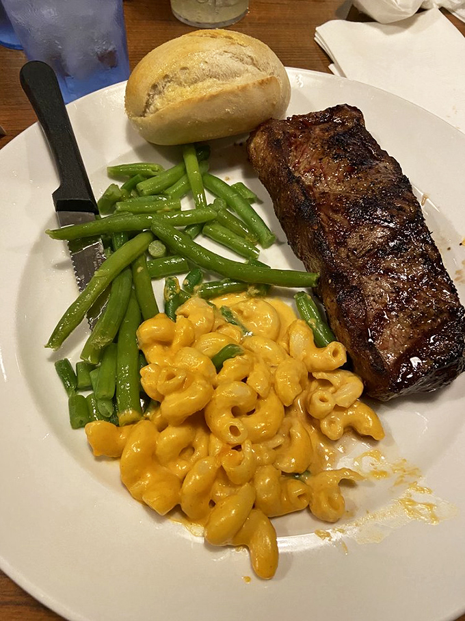 A perfectly seared steak with mac and cheese that proves Charlie's mastery extends well beyond the water's bounty.