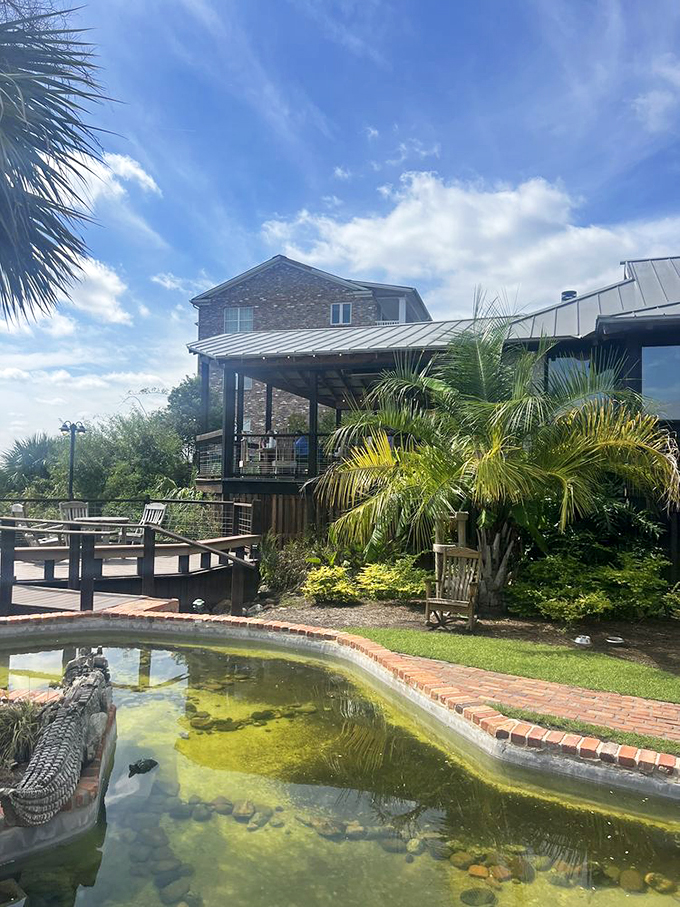 Beyond the dining room lies a slice of coastal paradise complete with palm trees and yes, that's an alligator sculpture in the pond.