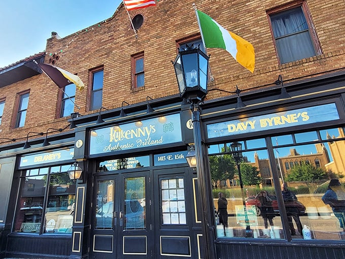 The brick facade of Kilkenny's stands proudly on Cherry Street, its vintage Guinness murals and emerald signage promising authentic Irish comfort in the heart of Tulsa.