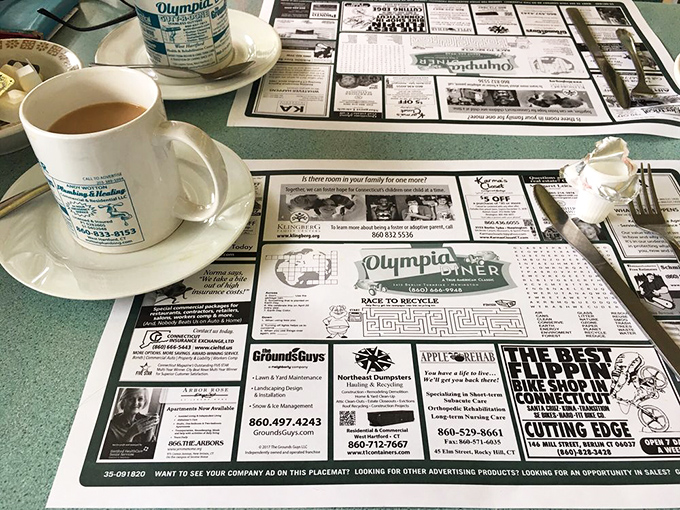 Coffee mugs and paper placemats—the diner's version of fine china and linen. Those local ads are Connecticut's original social network.