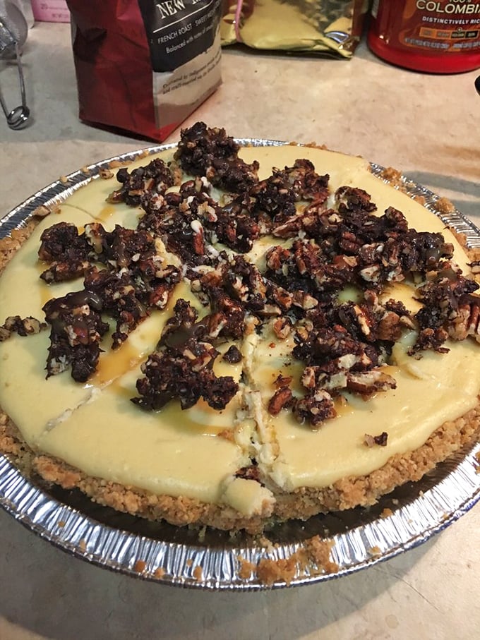 Turtle cheesecake topped with candied pecan clusters. This isn't just dessert—it's edible architecture designed to make you swoon.