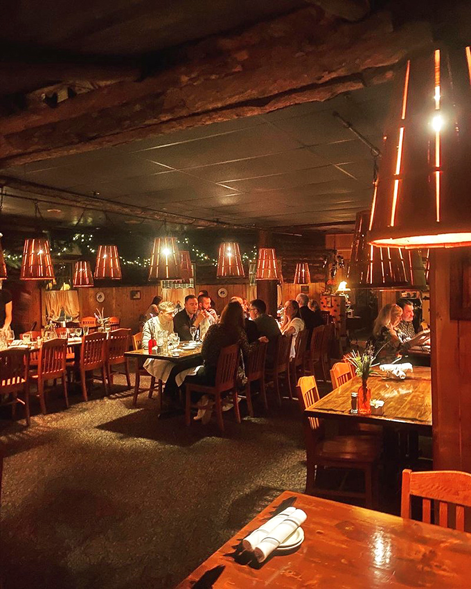 The evening ambiance transforms the cabin into a buzzing hive of happiness, where strangers become friends over shared love of perfectly cooked seafood.