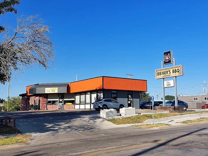 Biemer's BBQ: "That orange building isn't winning beauty pageants, but inside? Pure BBQ magic that'll make your taste buds dance like nobody's watching."