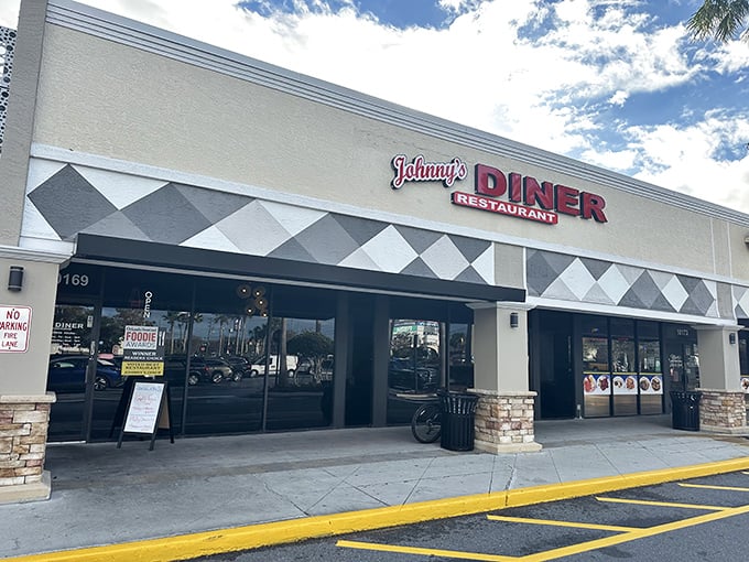 Johnny's Diner exterior beckons with its classic black and white diamond pattern &ndash; like a chess board where every move leads to delicious victory.