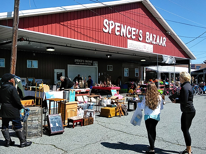 Spence's Bazaar: The red barn of bargain dreams where treasure hunters gather like it's the Super Bowl of secondhand finds.