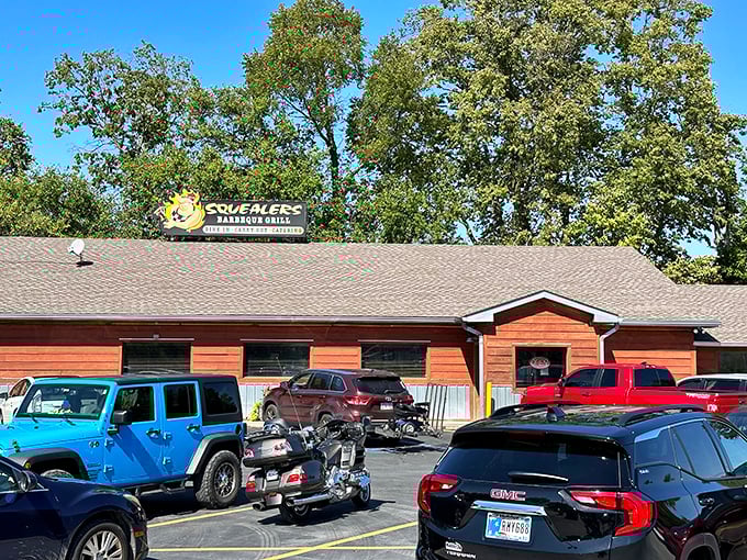 Squealers' rustic wooden exterior hides a BBQ paradise inside. That packed parking lot tells you everything you need to know about what awaits.