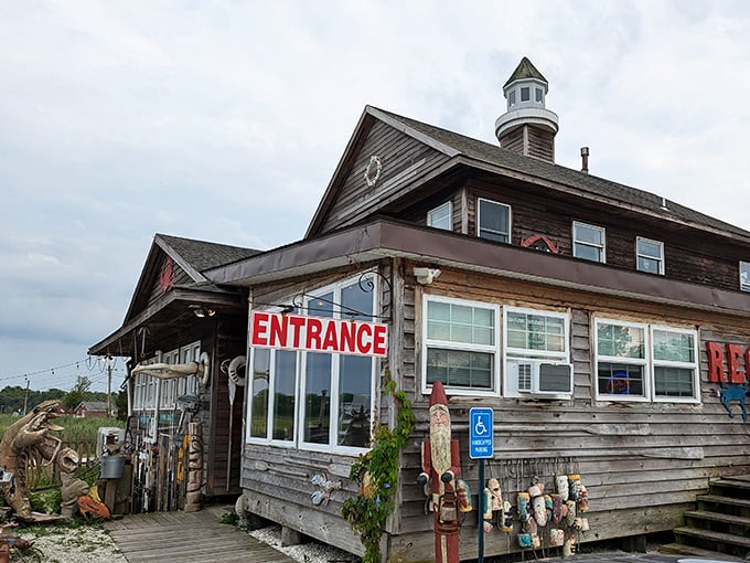 Step inside this weather-worn lighthouse treasure! That "ENTRANCE" sign promises seafood magic waiting just beyond those wooden doors.
