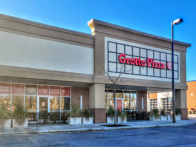 The bright red sign beckons like a lighthouse for the pizza-starved, promising those signature sauce spirals that haunt your dreams.