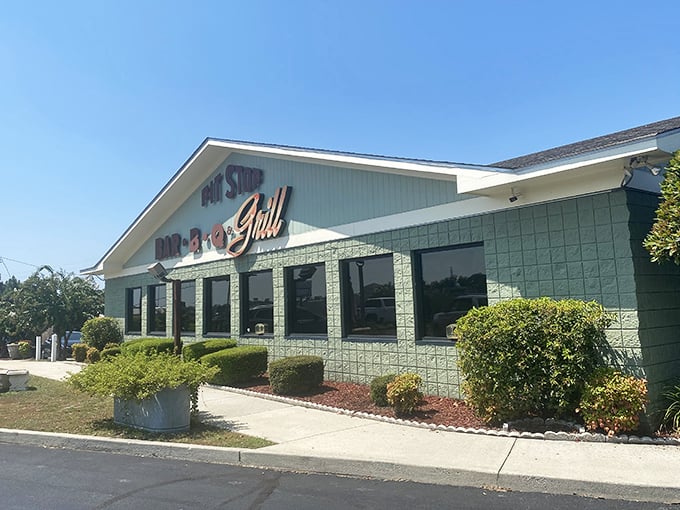 The mint-green charm of Pit Stop Bar-B-Q welcomes hungry travelers like a barbecue oasis in the Georgia heat.