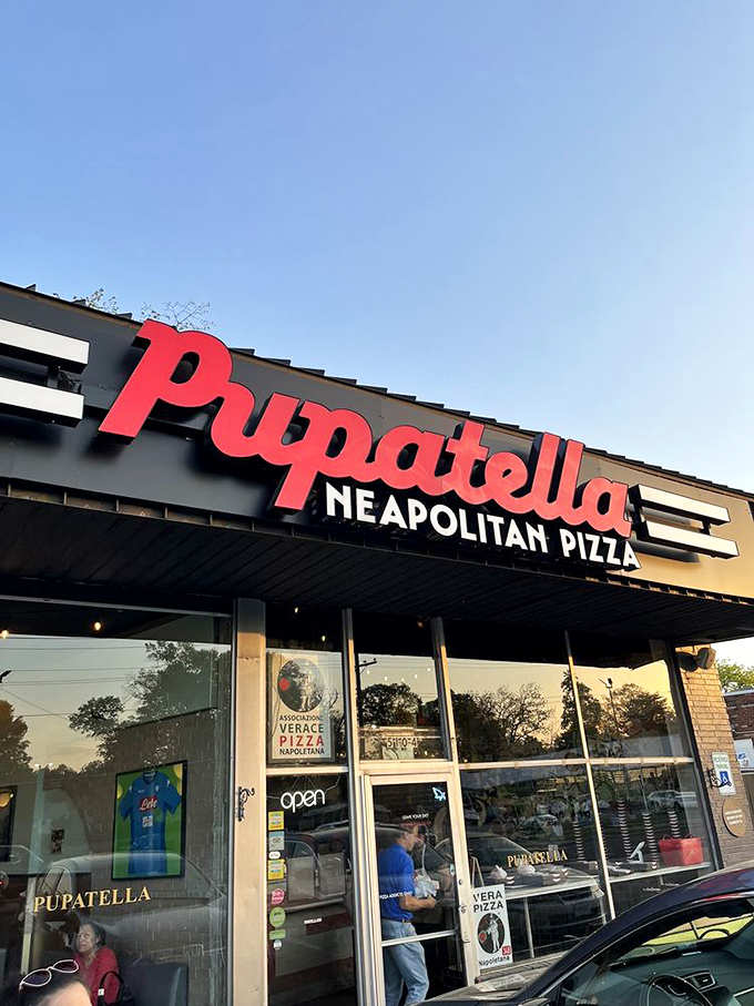 Pupatella's storefront beckons like a pizza lighthouse, guiding hungry souls to Neapolitan nirvana. That red sign promises authentic bliss.