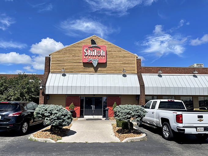 Shiloh Steakhouse (entrance): "The red sign beckons like a meaty lighthouse guiding hungry sailors to shore. Your steak adventure begins here."