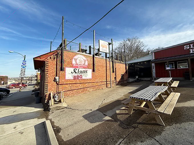 Slap's brick exterior might be humble, but that rooftop deck is where BBQ dreams come with a side of Kansas City skyline.